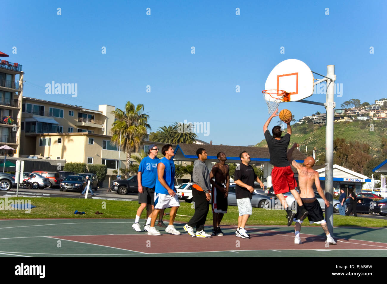 Men playing basketball on the California beach Stock Photo - Alamy