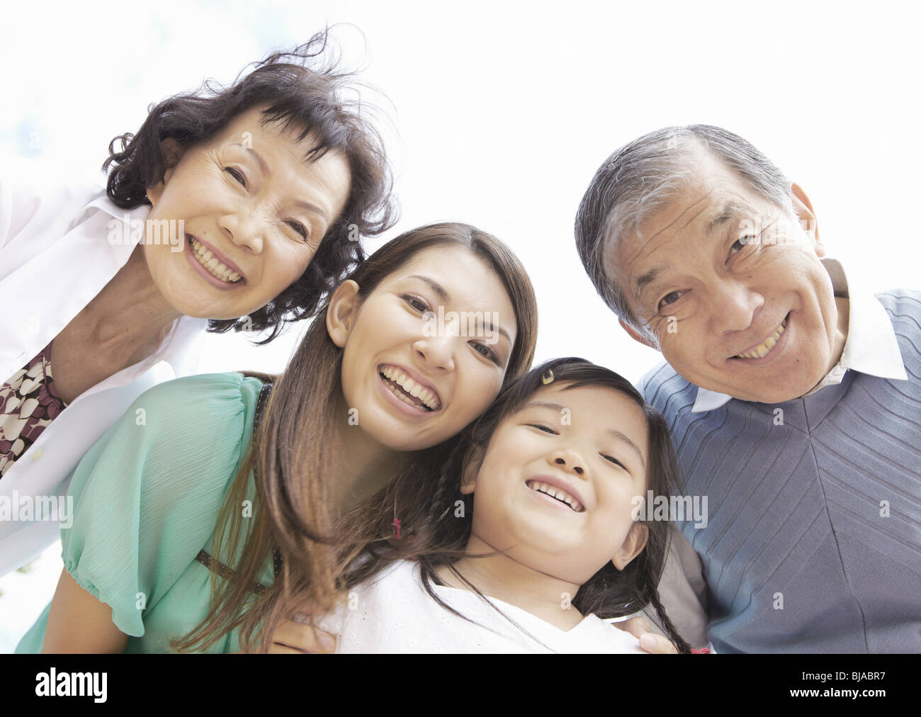 Three-generation family smiling Stock Photo - Alamy