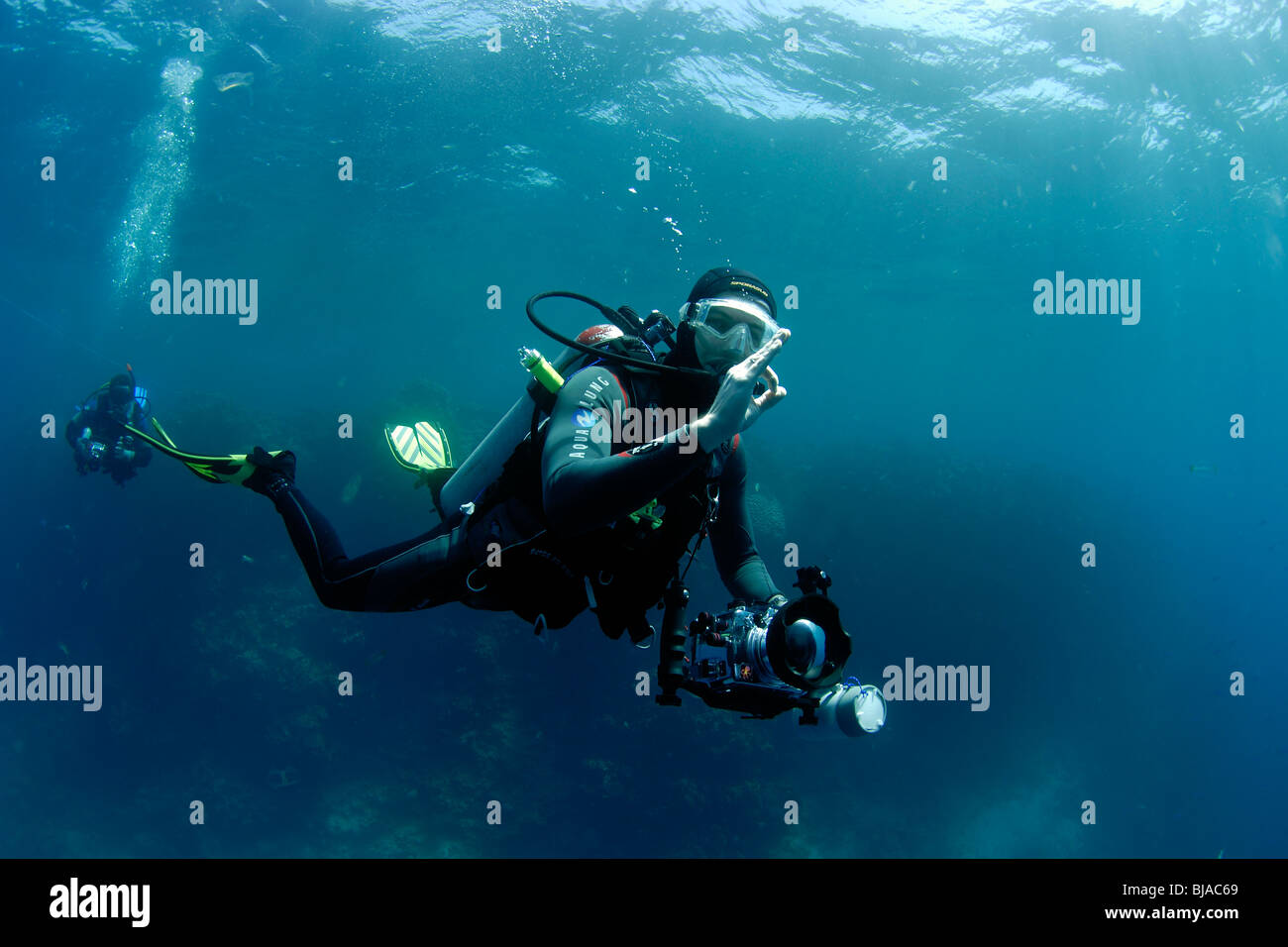 Scuba diver doing th sign OK with one hand and holding a camera Stock ...