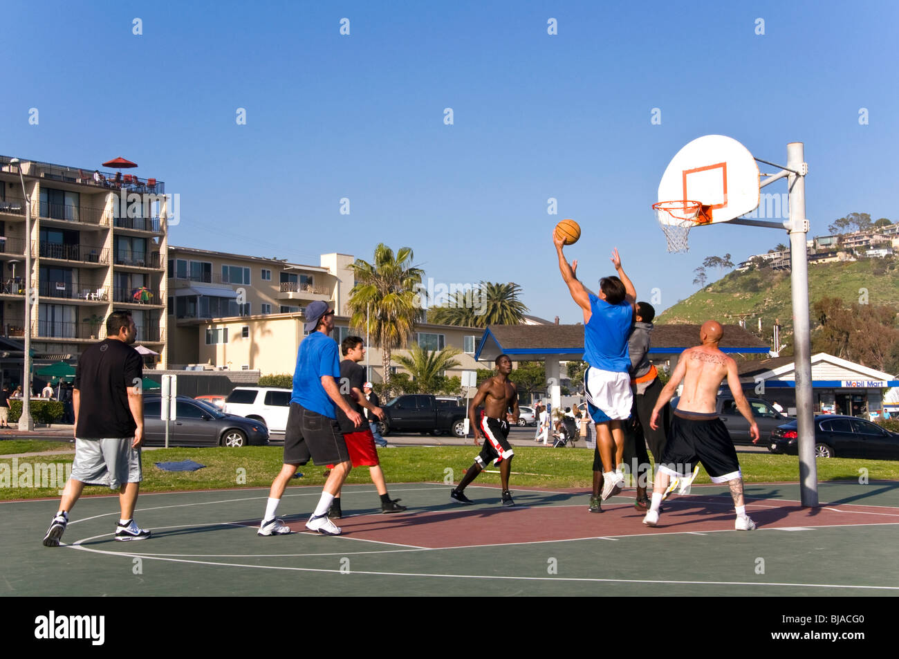 Men playing basketball on the California beach Stock Photo - Alamy