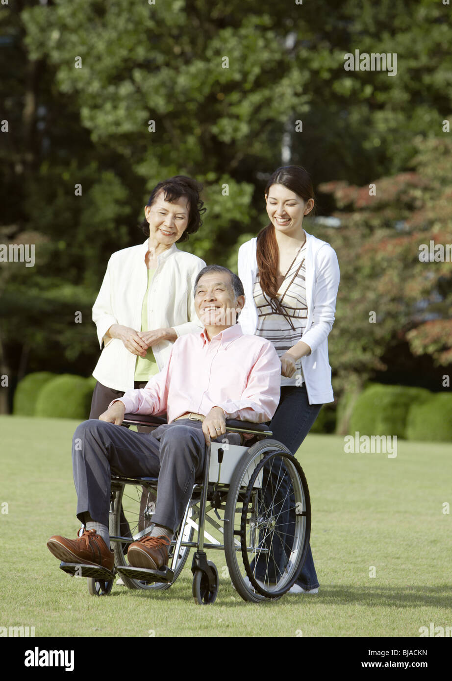 Senior man in wheelchair and family Stock Photo - Alamy