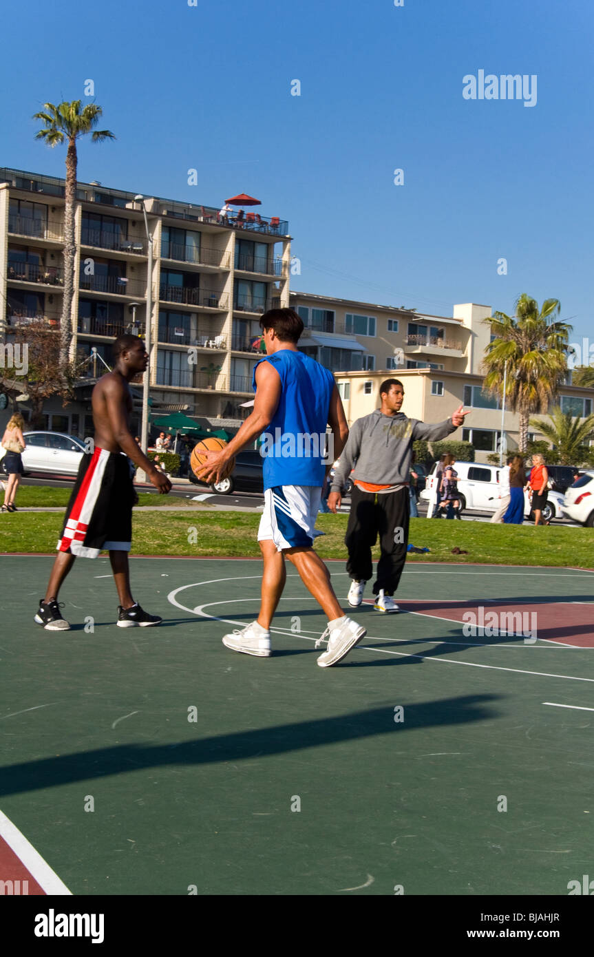 Men playing basketball on the California beach Stock Photo - Alamy
