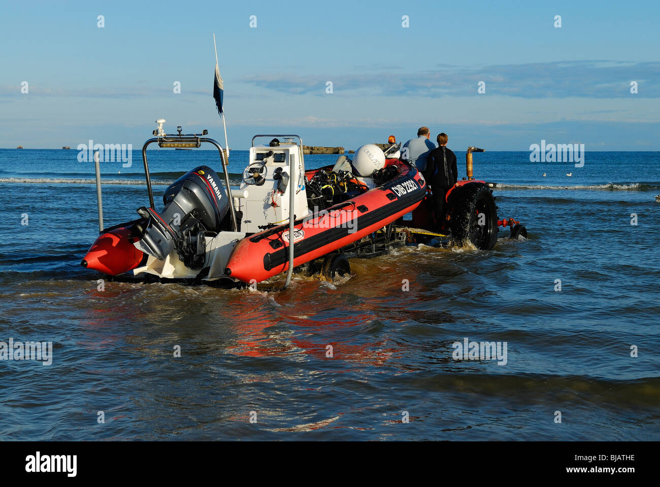 Farm tractor pulling an inflatable diving boat, Normandy, France Stock ...