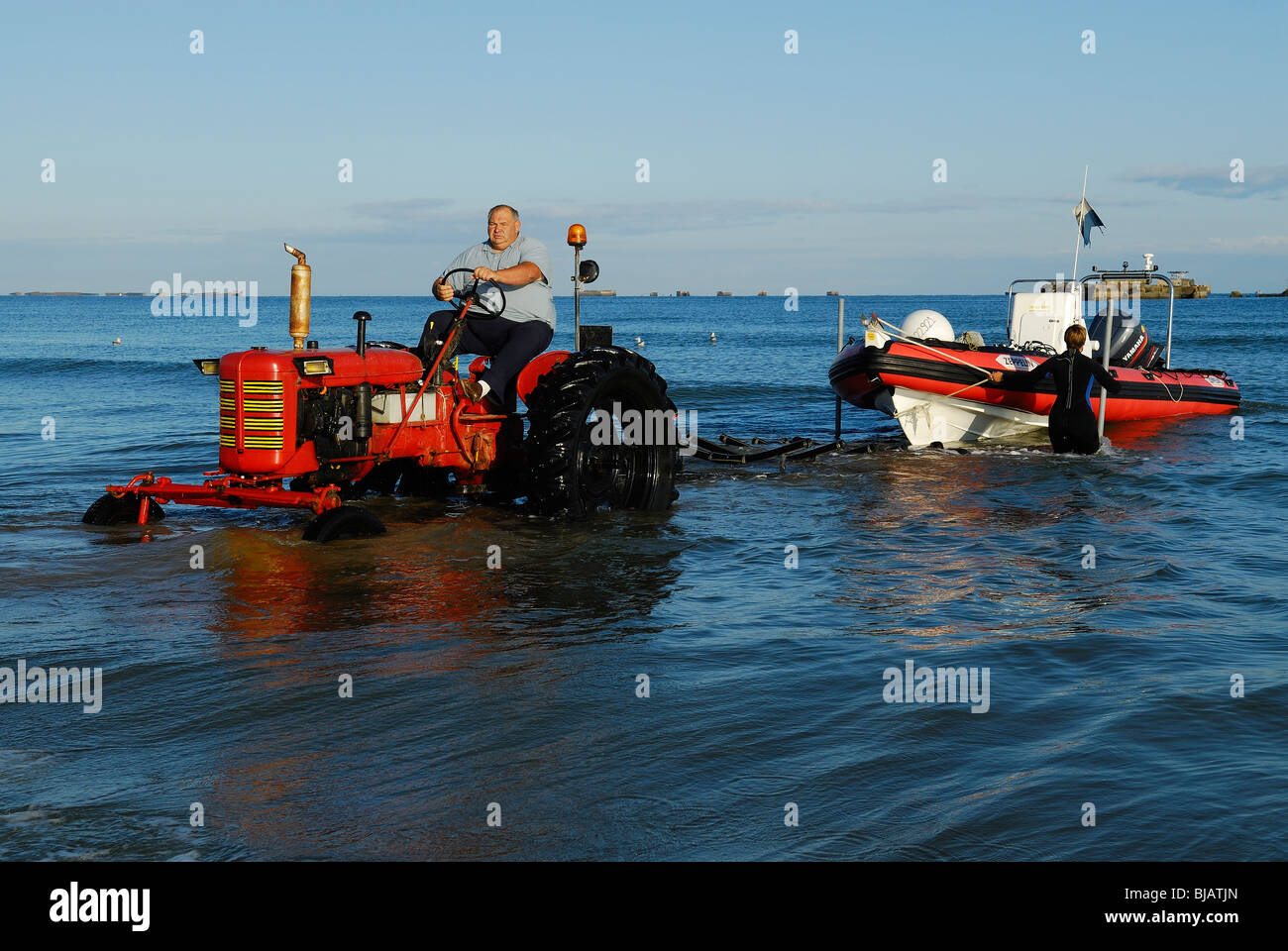 Farm tractor pulling an inflatable diving boat, Normandy, France Stock ...