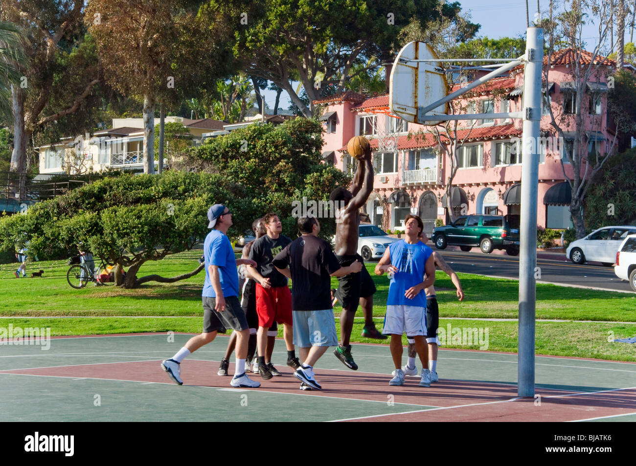 Men playing basketball on the California beach Stock Photo - Alamy