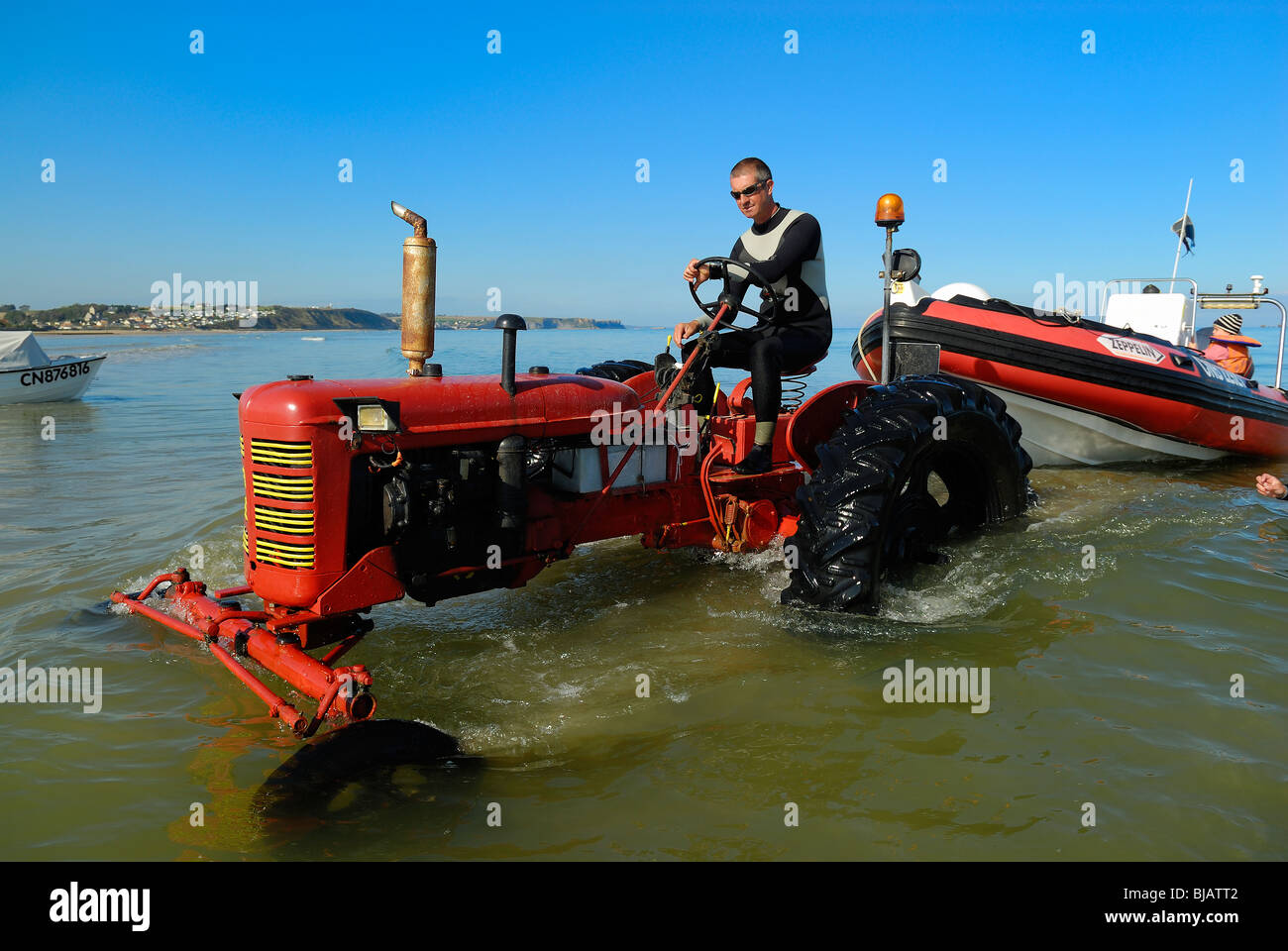 Farm tractor pulling an inflatable diving boat, Normandy, France Stock ...