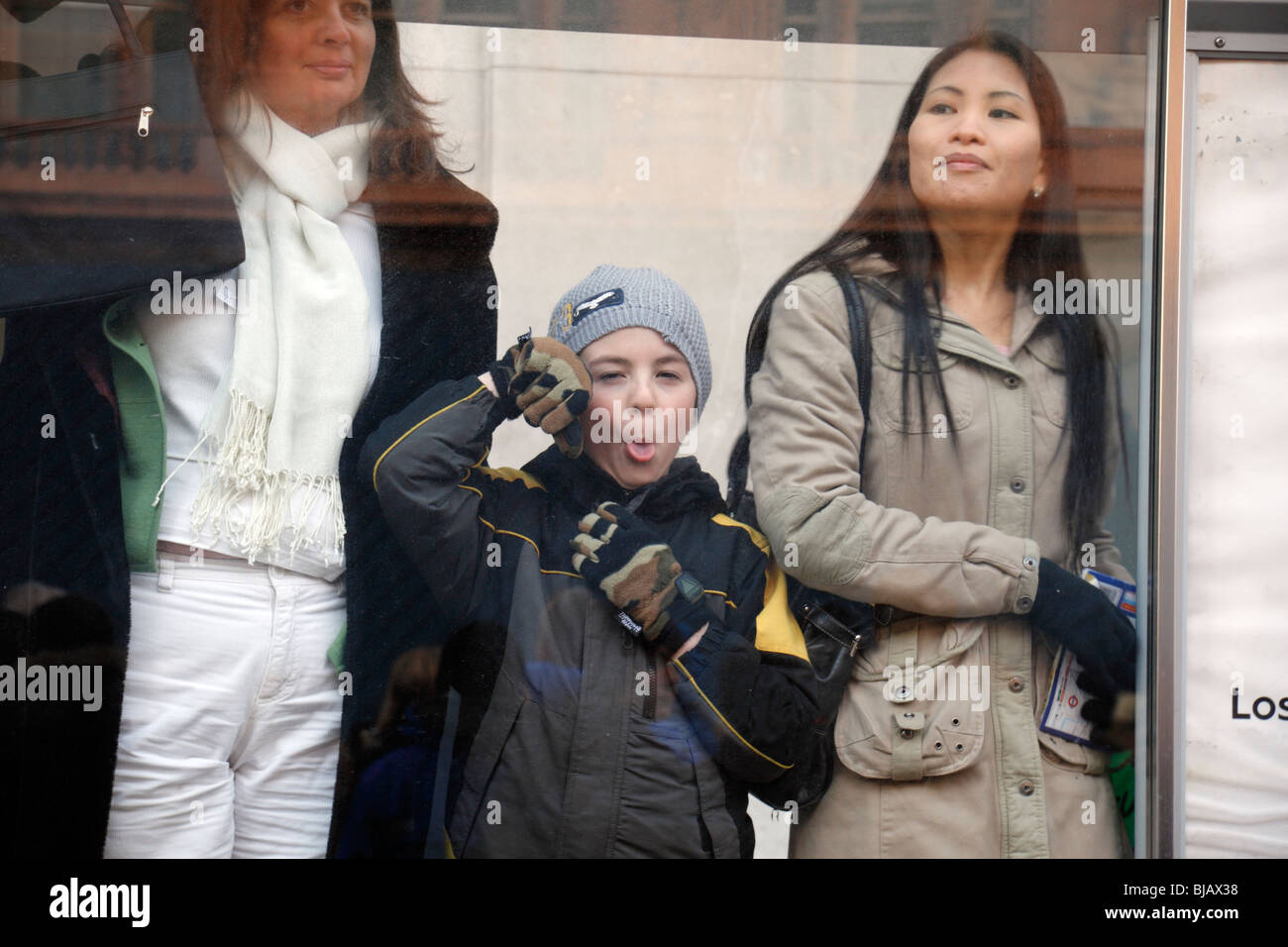 Child pulling face and sticking his tongue out at a photographer at a ...