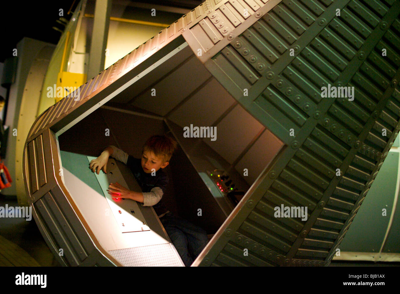 Young boy playing in a replica of a space capsule at the National Space ...
