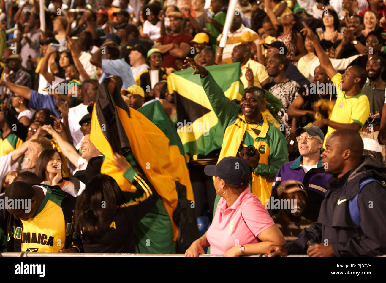 Sea of Jamaicans waving flags, overwhelmed with joy after countryman ...