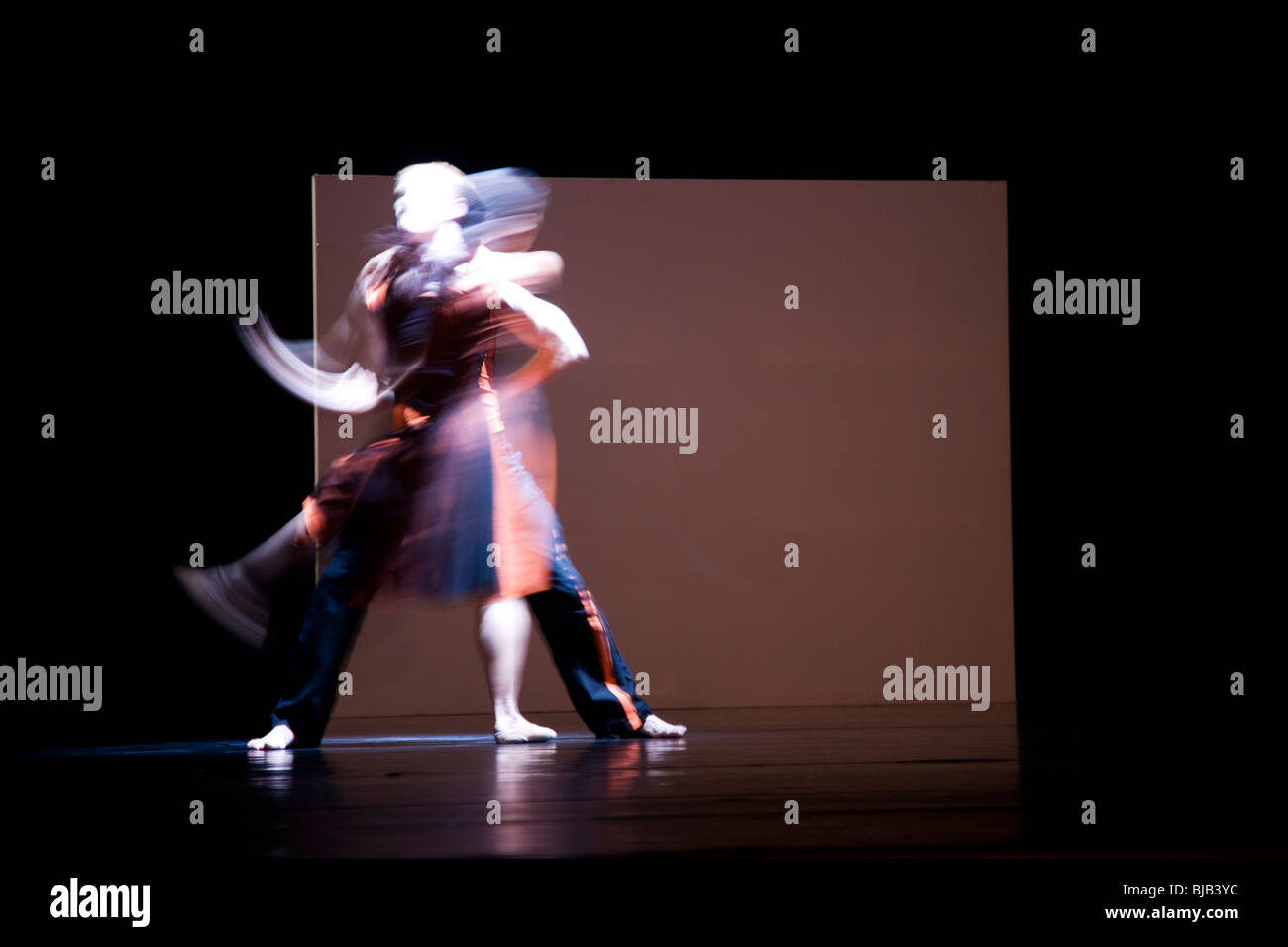 Two dancers captured in blurred movement in a modern ballet production ...