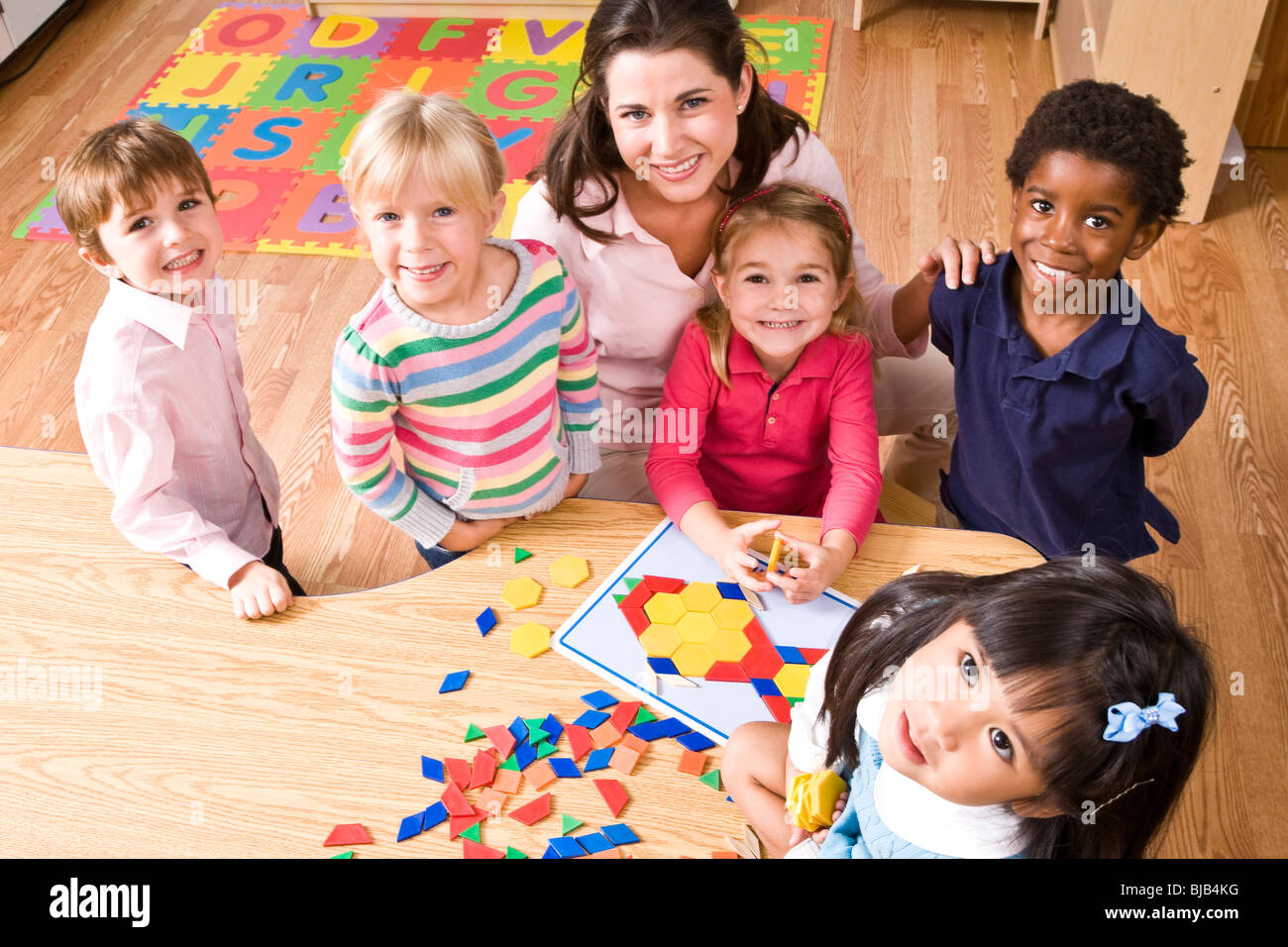 Group of children with teacher in preschool learning shapes Stock Photo ...