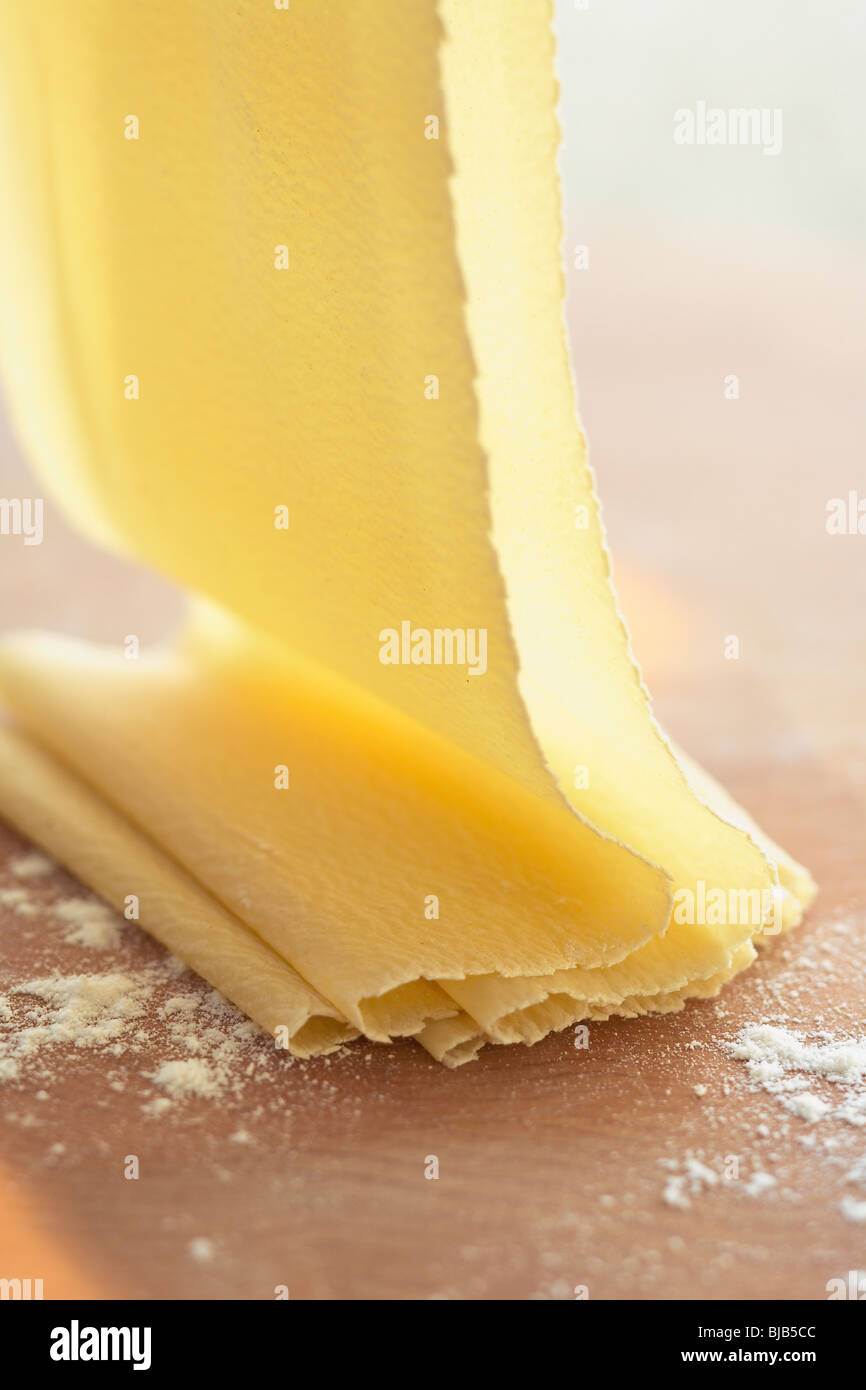 Fresh egg pasta drying hanging Stock Photo - Alamy