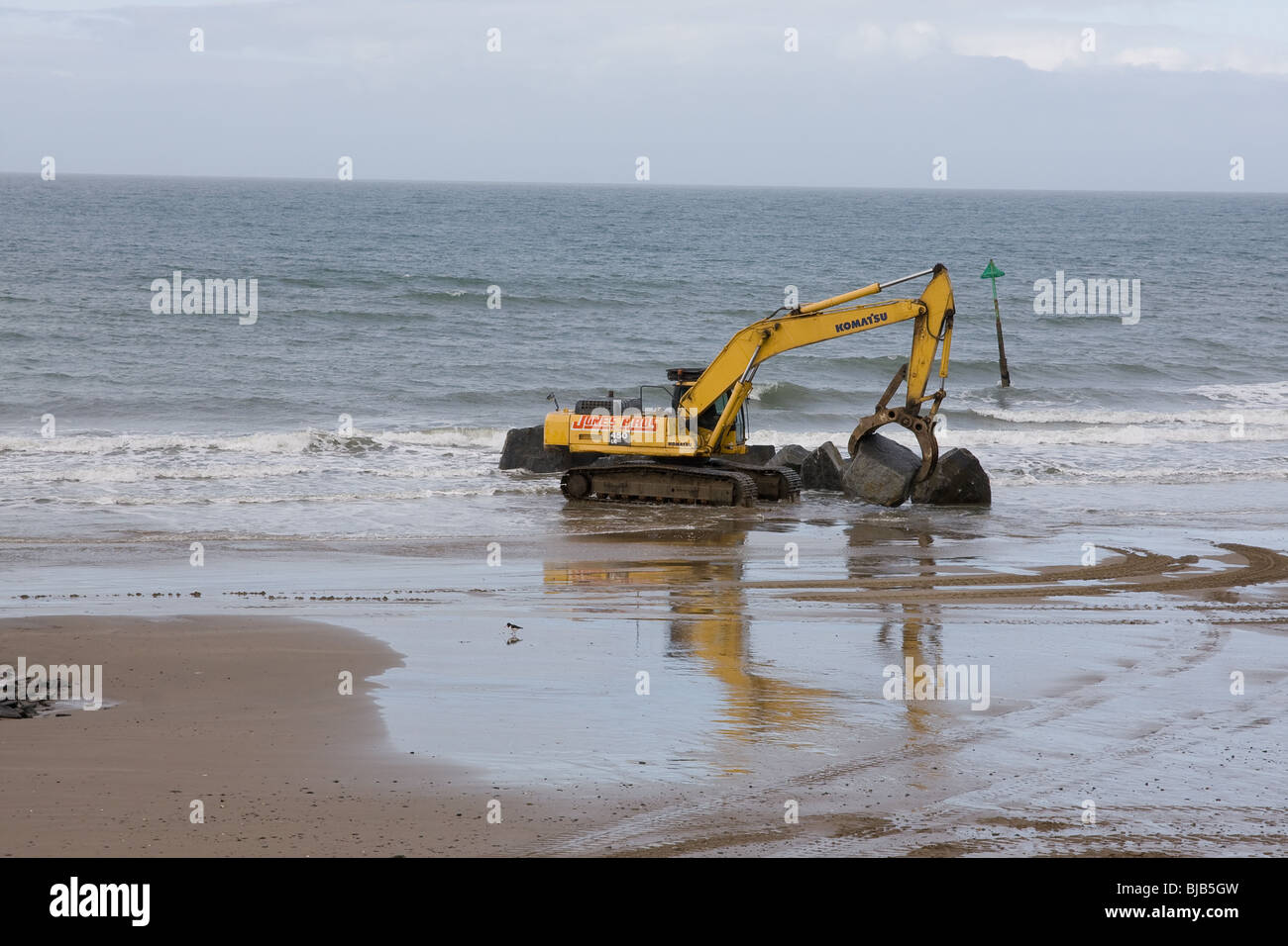 Moving boulders on the beach, tywyn Stock Photo - Alamy