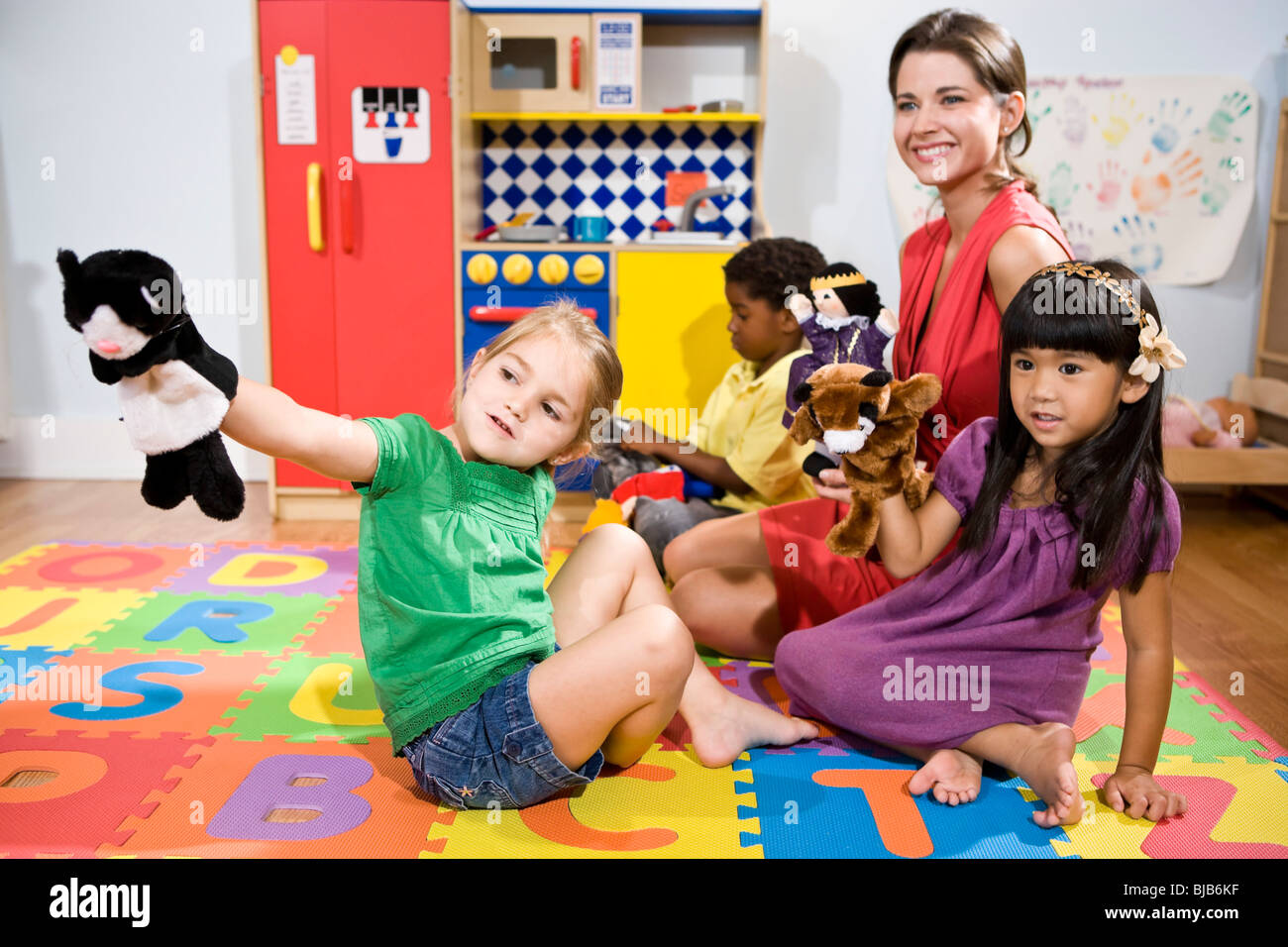 Teacher with preschool children playing with puppets Stock Photo - Alamy