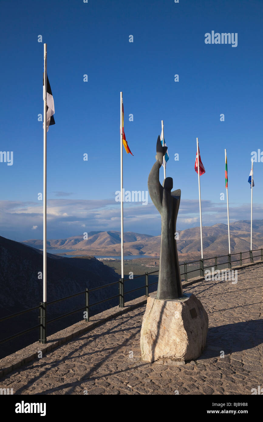 Flags and modern statue of Prometheus in Delphi,Greece Stock Photo - Alamy