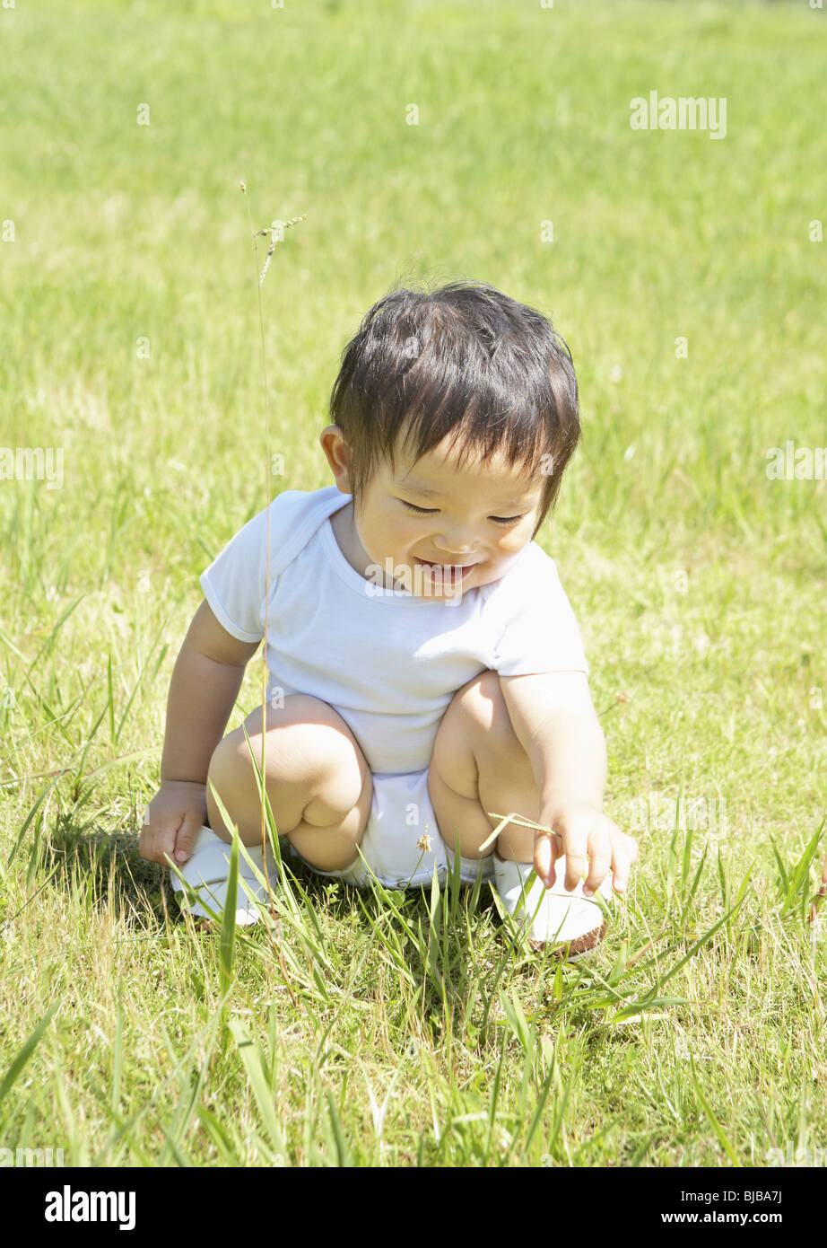 Boy playing on grass Stock Photo - Alamy