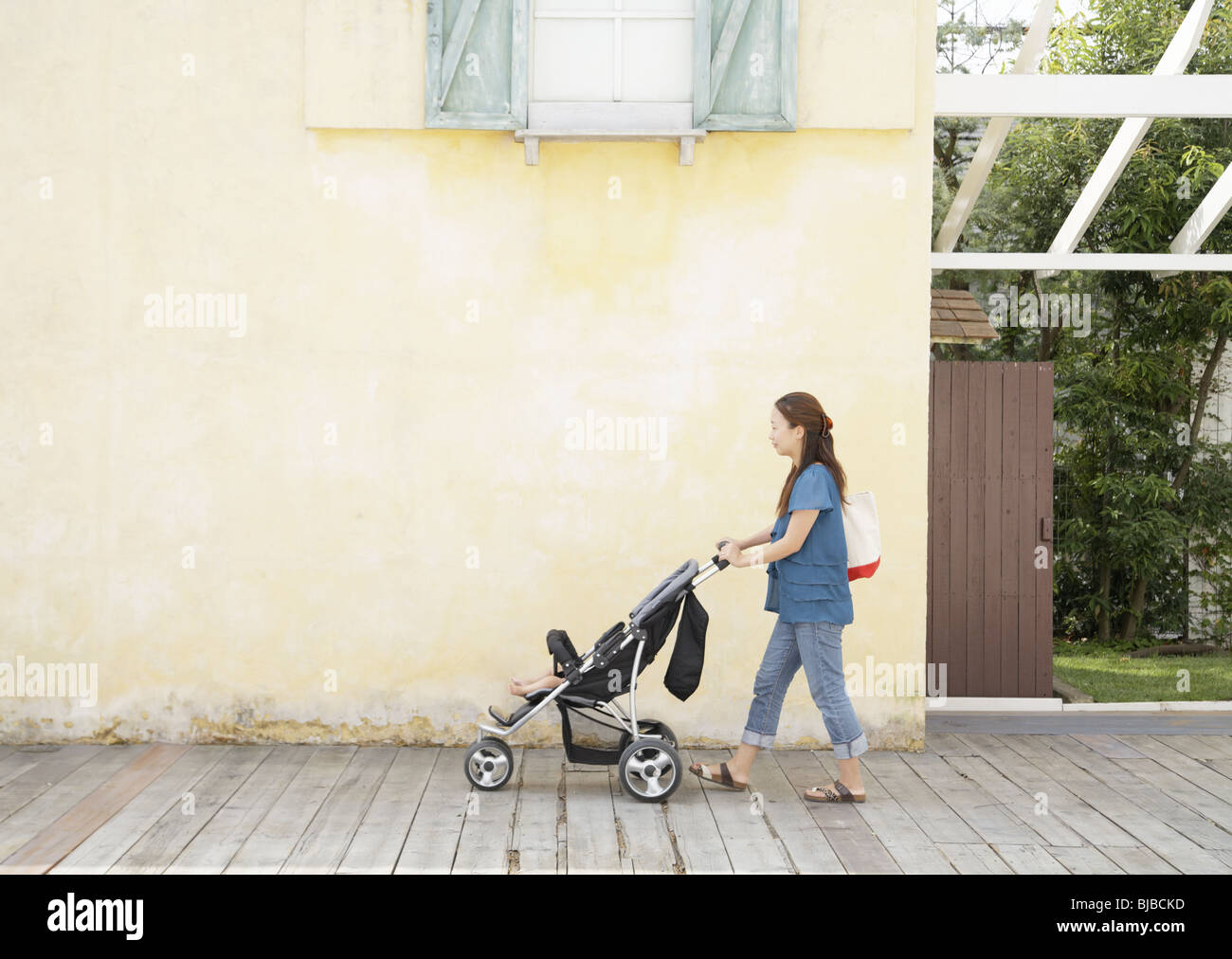 Mother pushing a baby buggy Stock Photo - Alamy