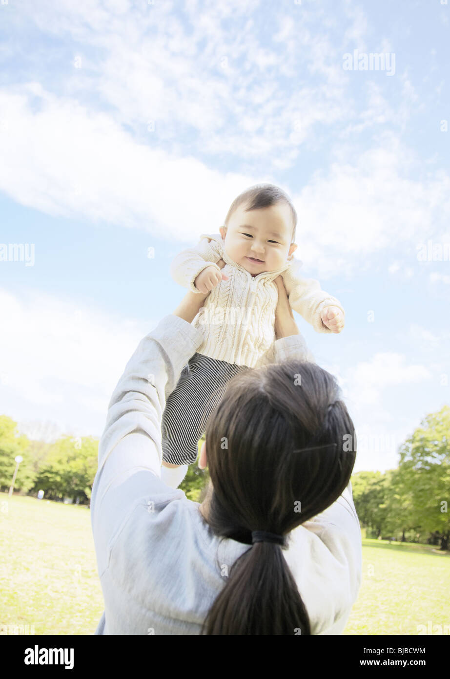 Mother taking baby up Stock Photo - Alamy