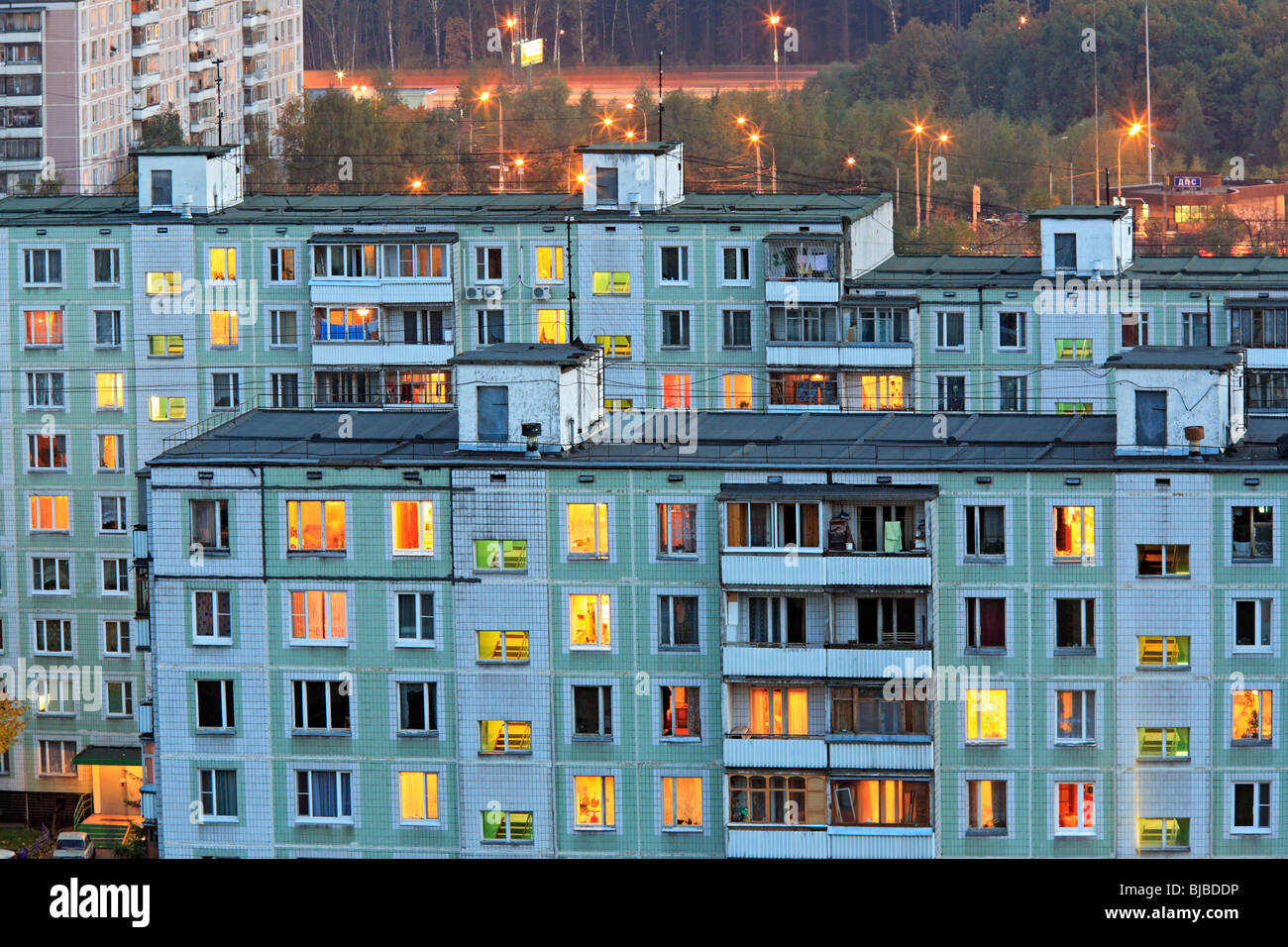 Cityscape, city, 1980s apartment buildings in the evening with lights ...