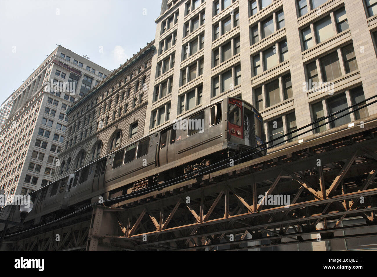 An elevated LOOP train passing office builindgs in Chicago Downtown ...