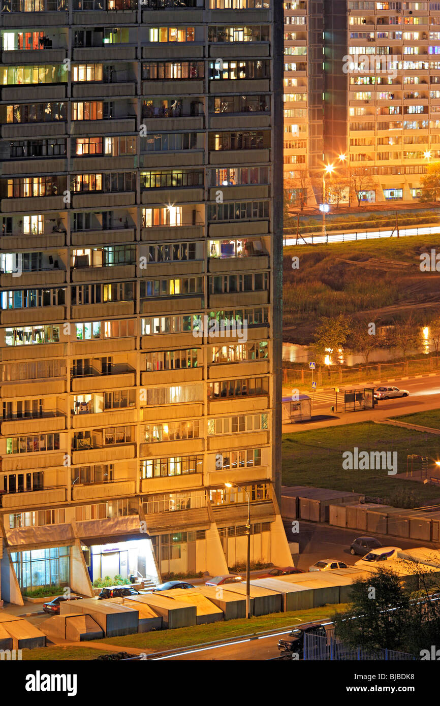 Cityscape, city, 1980s apartment buildings in the evening with lights ...