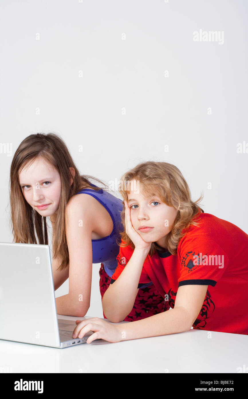 young boy and girl having fun with laptop computer Stock Photo - Alamy