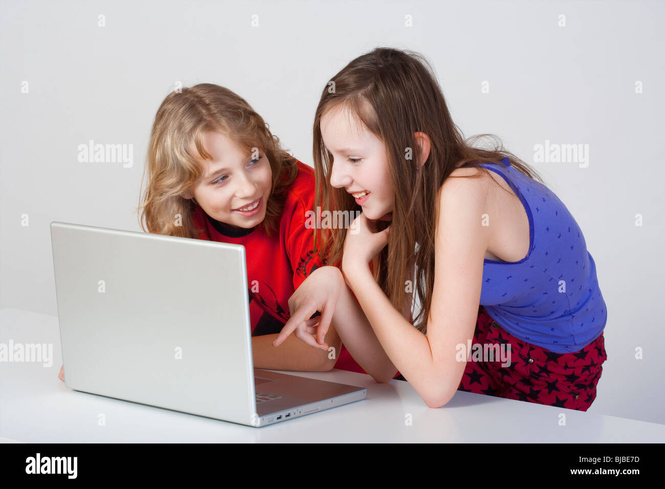 young boy and girl having fun with laptop computer Stock Photo - Alamy