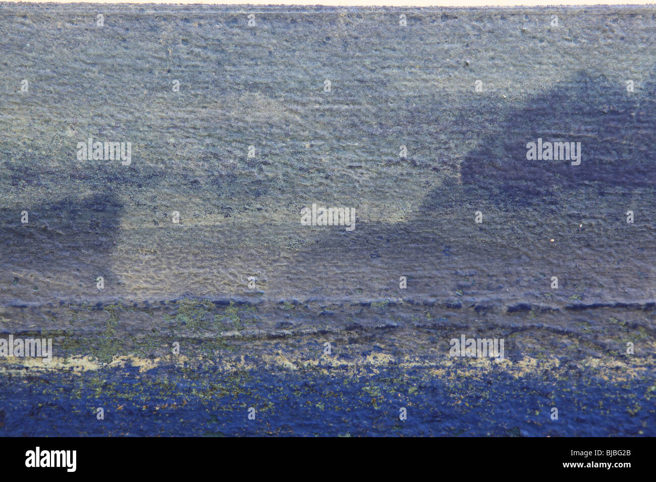 Abstract paint patterns on the hull of a boat before being re-painted ...
