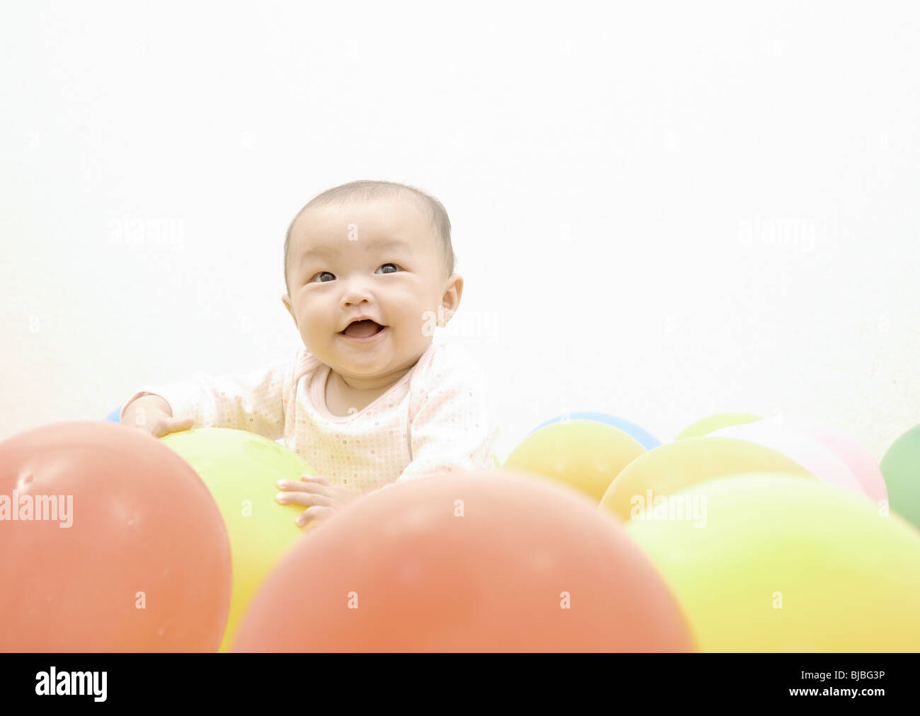 Baby playing with balloon Stock Photo - Alamy