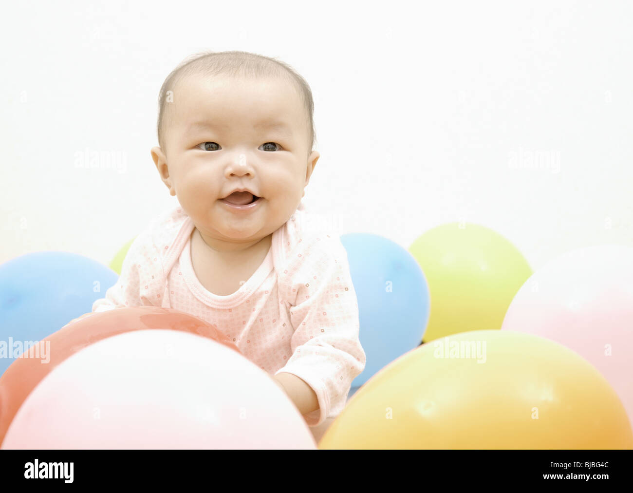 Baby playing with balloon Stock Photo - Alamy