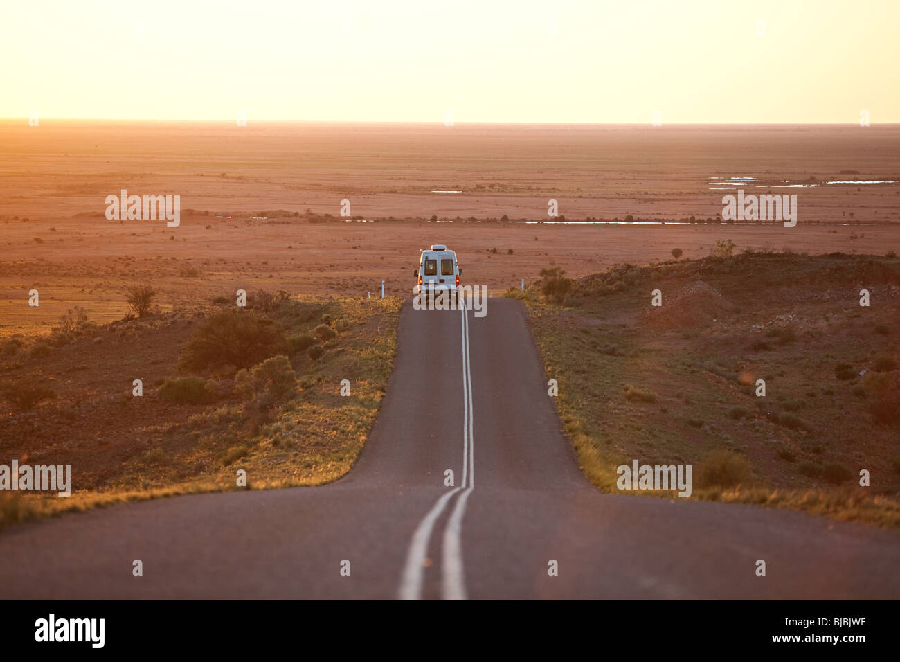 A camper van driving through Australian outback, Silverton NSW ...