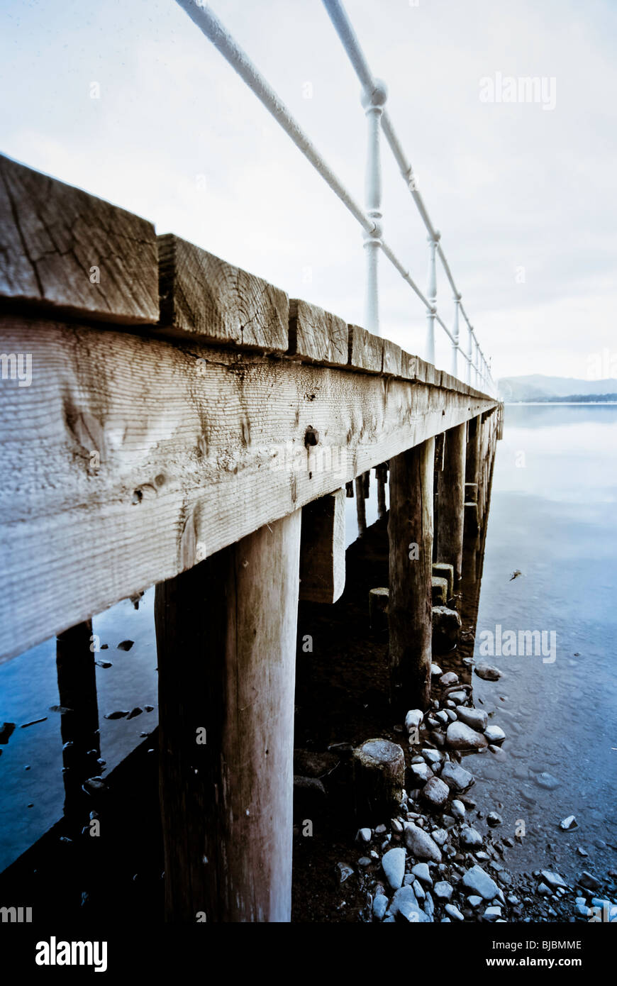 View down a jetty into a lake Stock Photo - Alamy