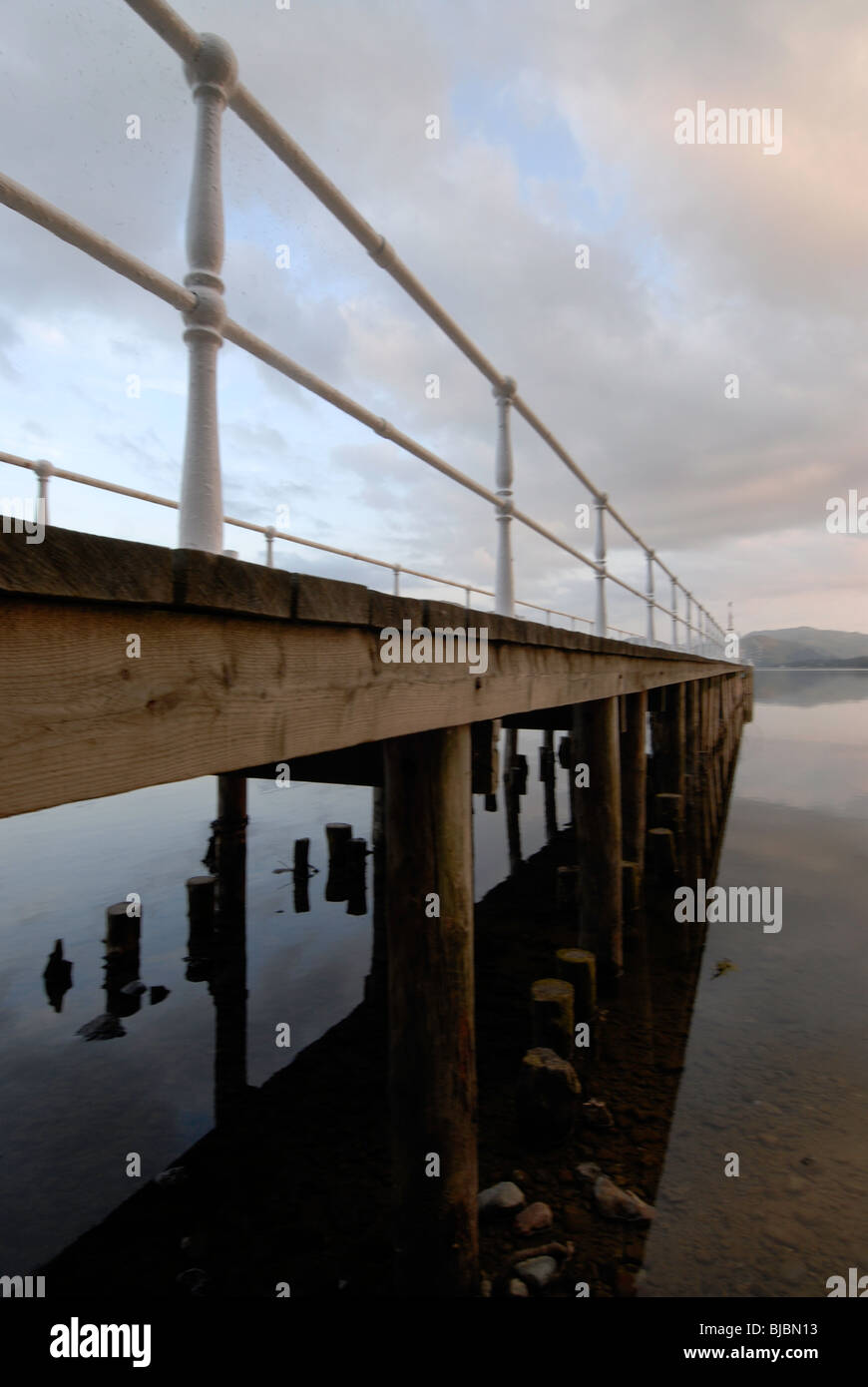 View down a jetty into a lake Stock Photo - Alamy
