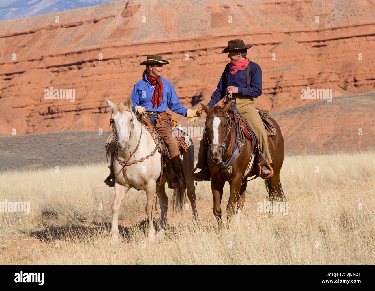 Cowboy and cowgirl holding hands Stock Photo - Alamy