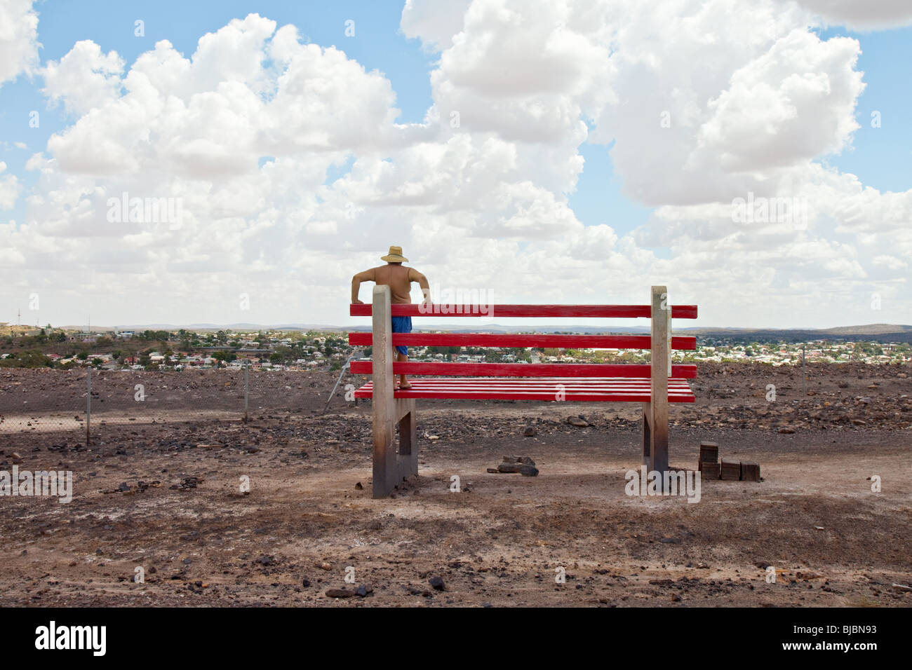 A man on a huge bench watching Broken Hill panorama, near modern ...