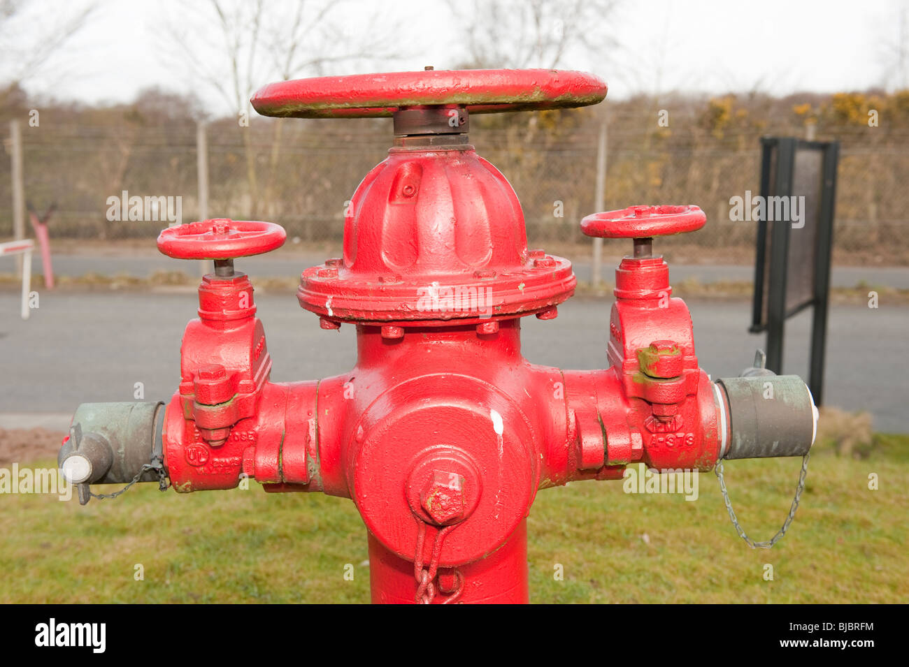 red fire hydrant with wheel valves Stock Photo - Alamy