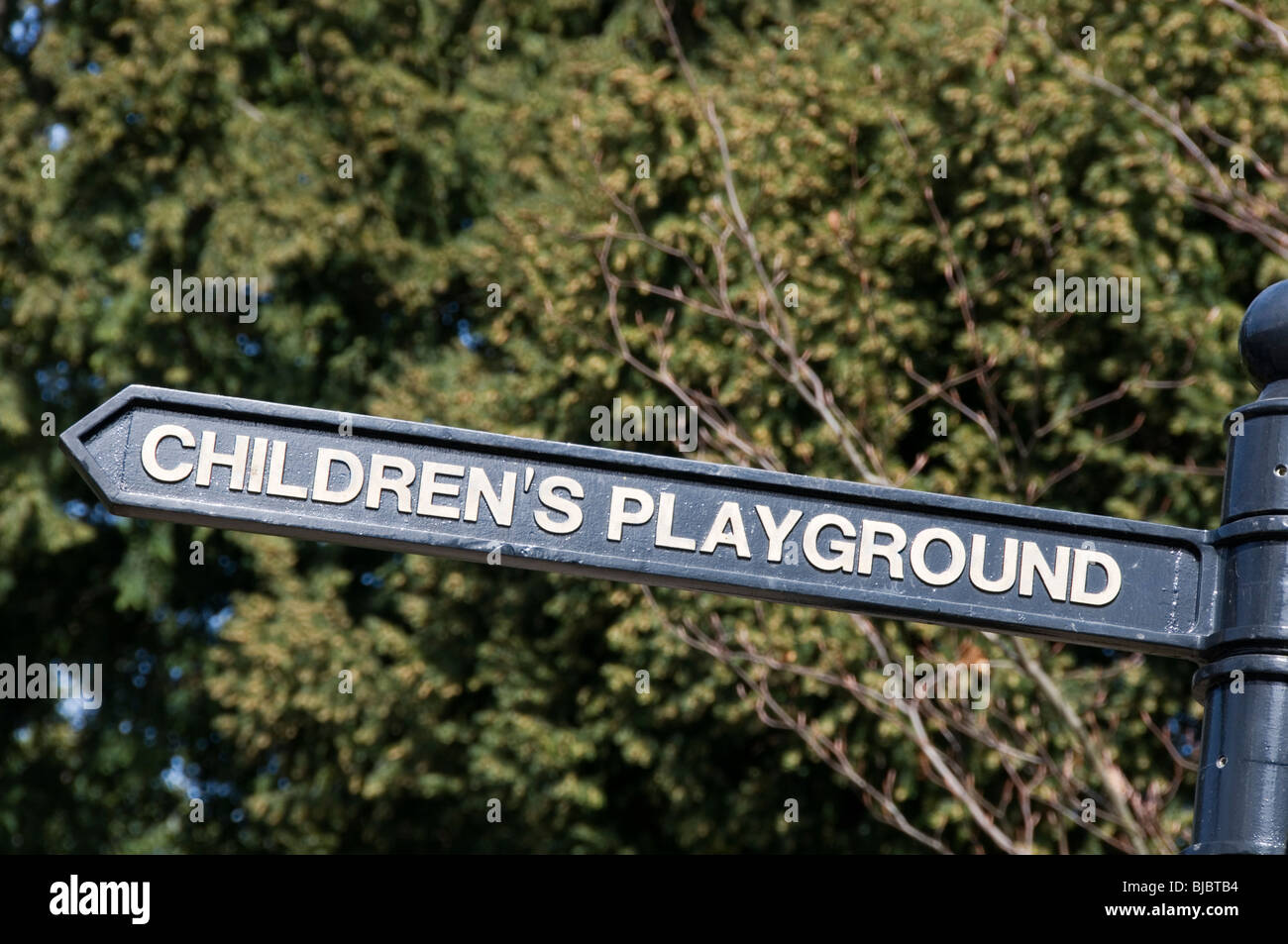 Fingerpost pointing to children's playground Stock Photo - Alamy