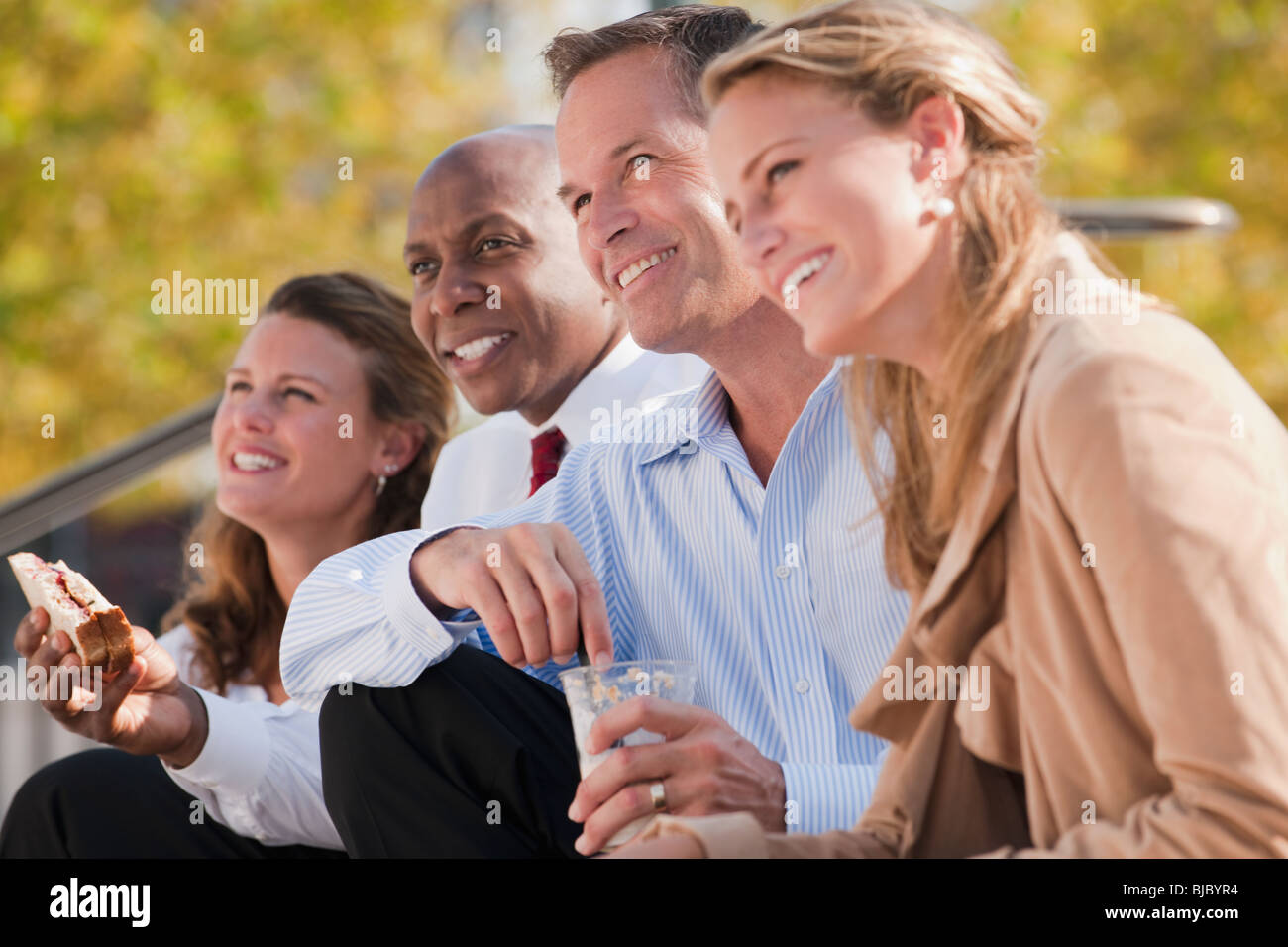 Business people eating lunch on steps Stock Photo - Alamy