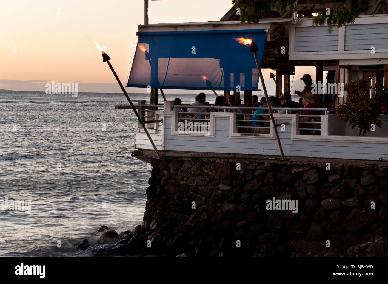 Tourists enjoying a sunset dinner in a restaurant on Front Street ...