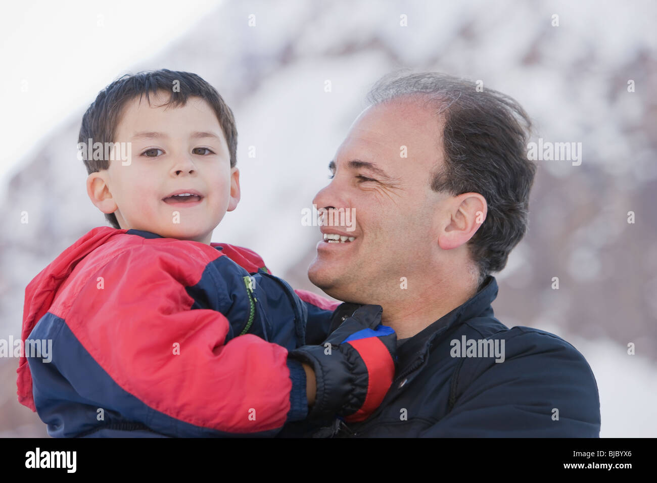 Hispanic father holding son Stock Photo - Alamy