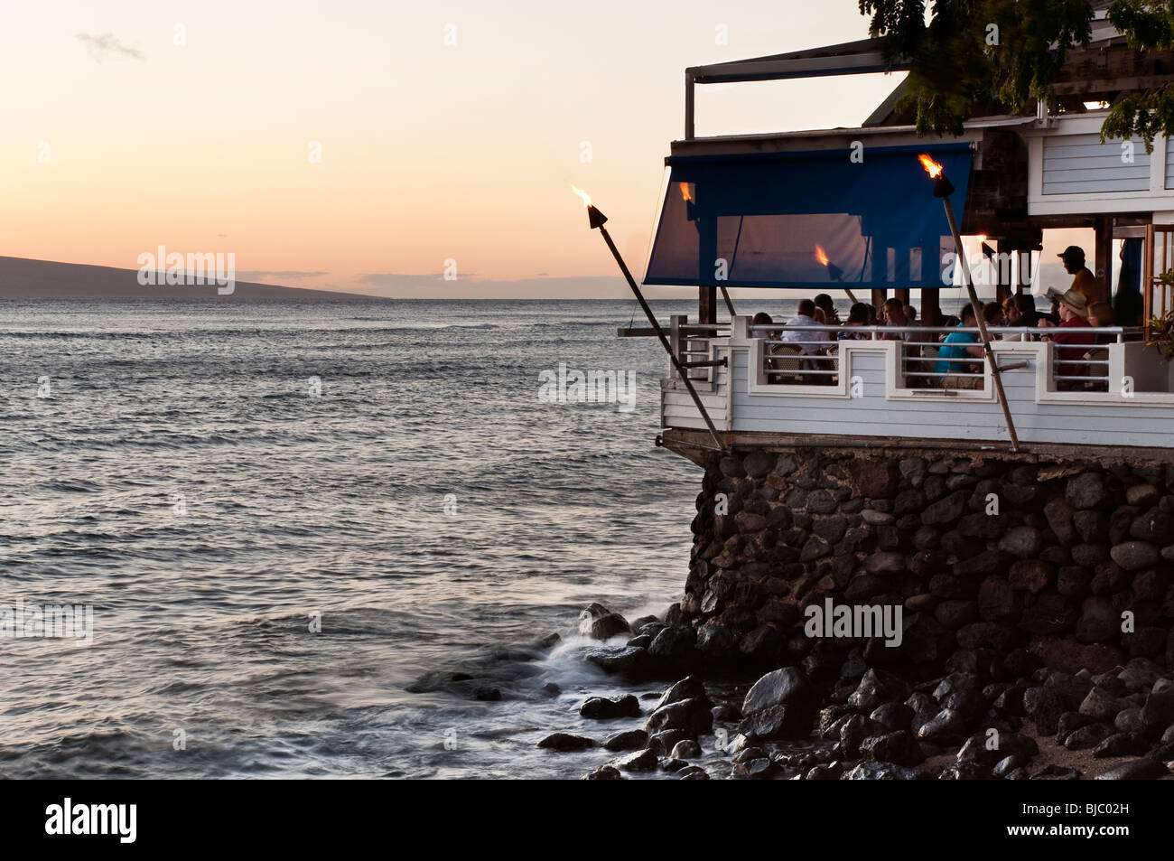 Tourists enjoying a sunset dinner in a restaurant on Front Street ...