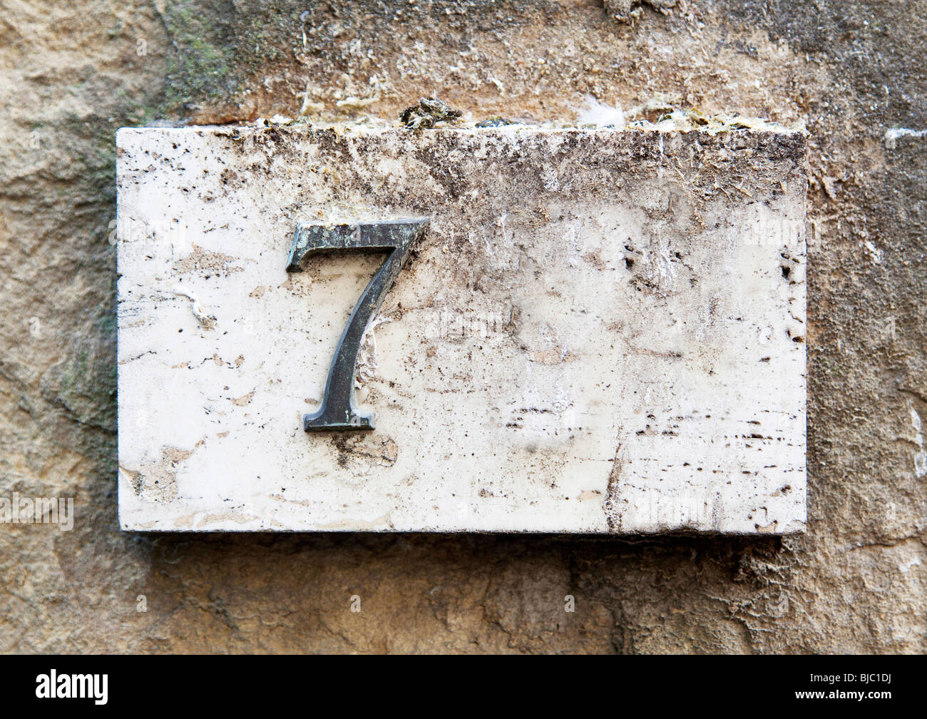 Block number on a weathered wall - detail Stock Photo - Alamy