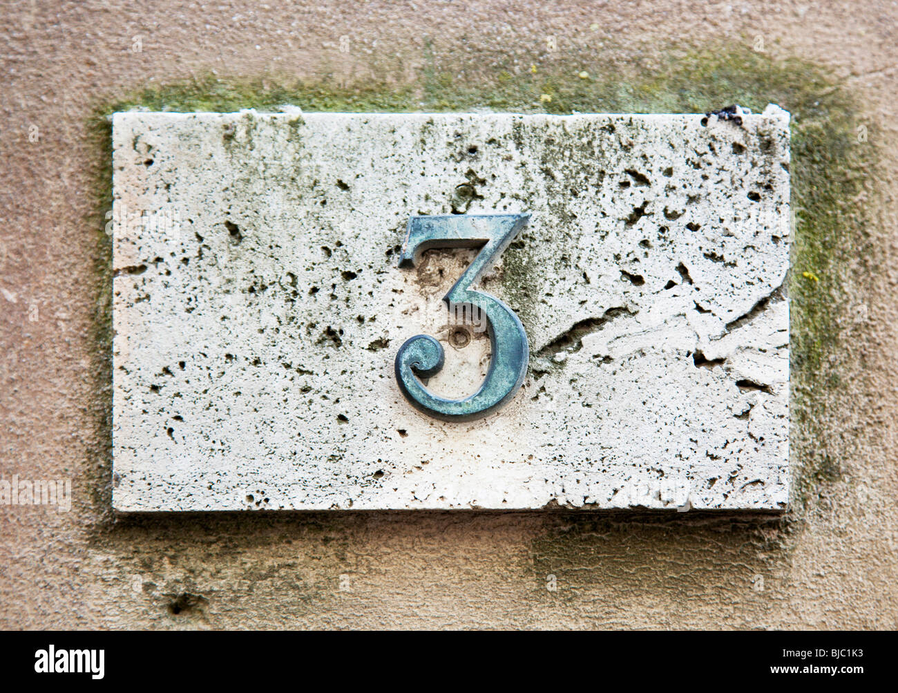 Block number on a weathered wall - detail Stock Photo - Alamy