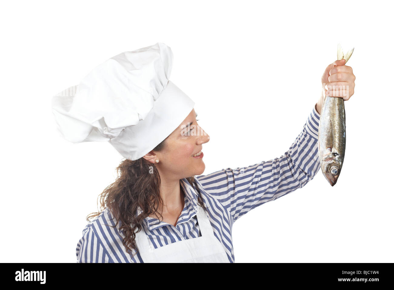 Cook woman holding a fresh fish isolated on white background Stock ...