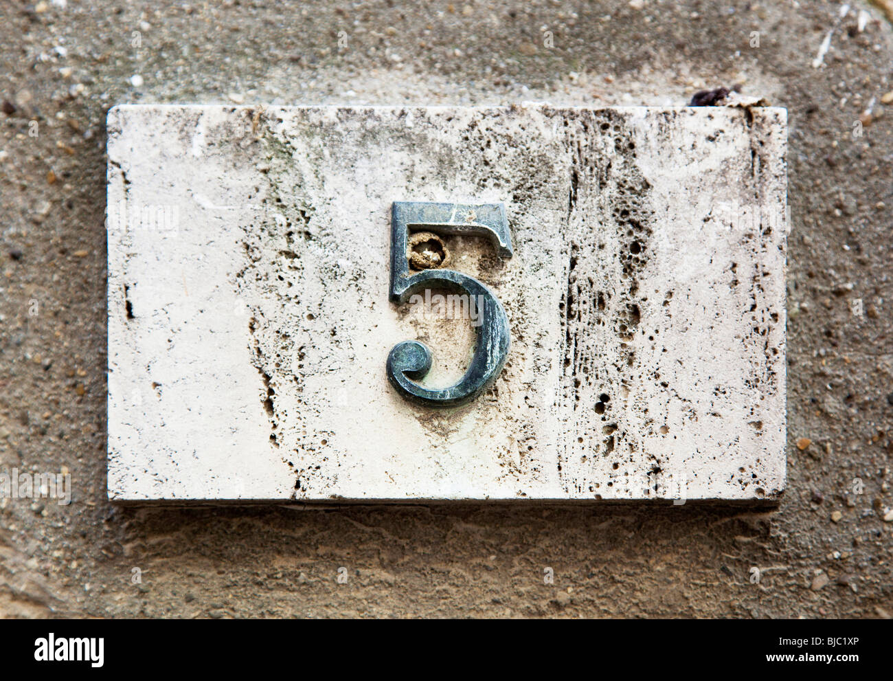 Block number on a weathered wall - detail Stock Photo - Alamy