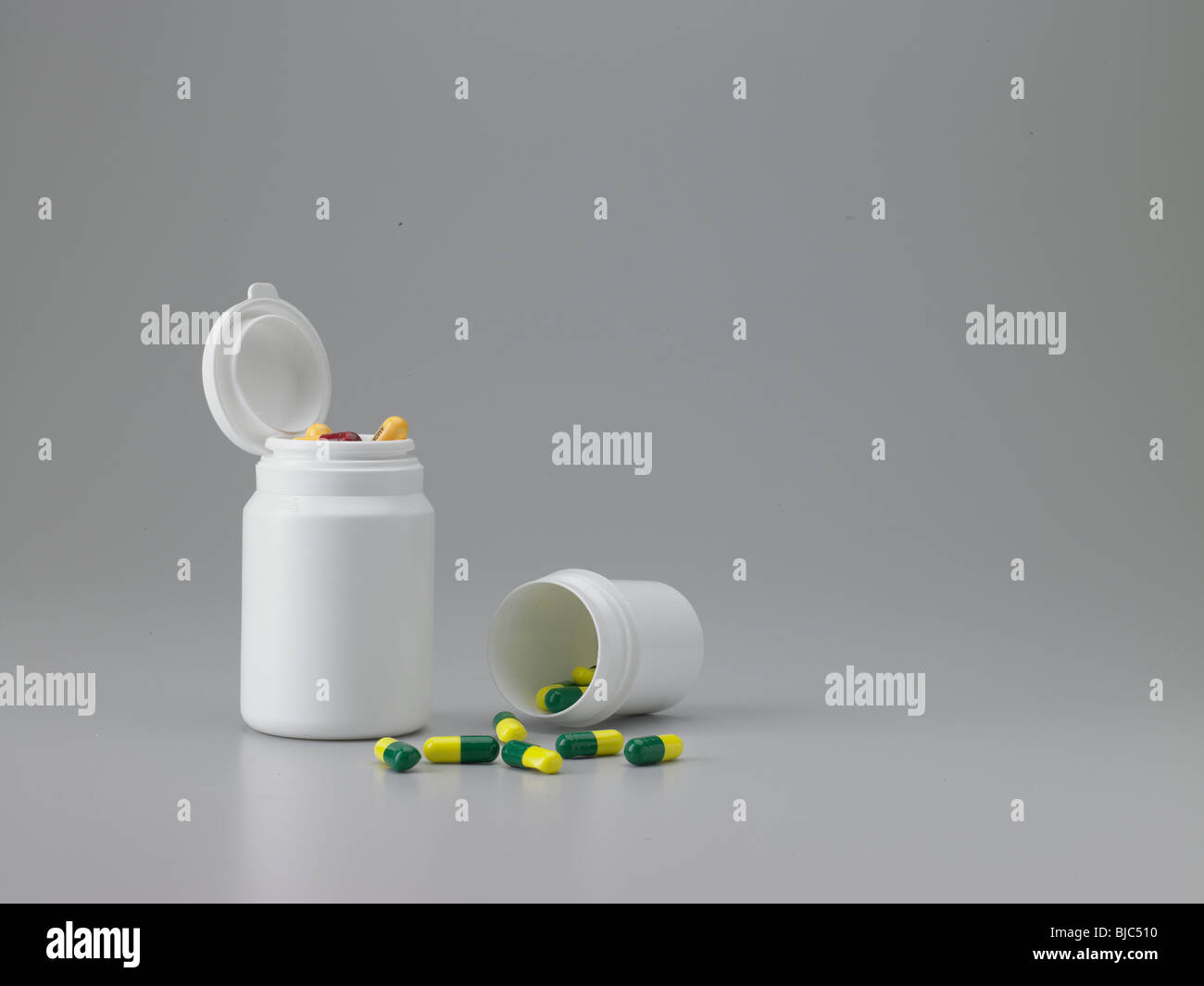 Tablets spilling from a medical container. Low angle. Landscape Stock ...