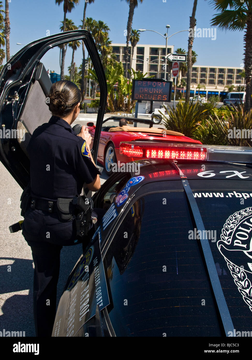 female police officer calls for backup Stock Photo - Alamy