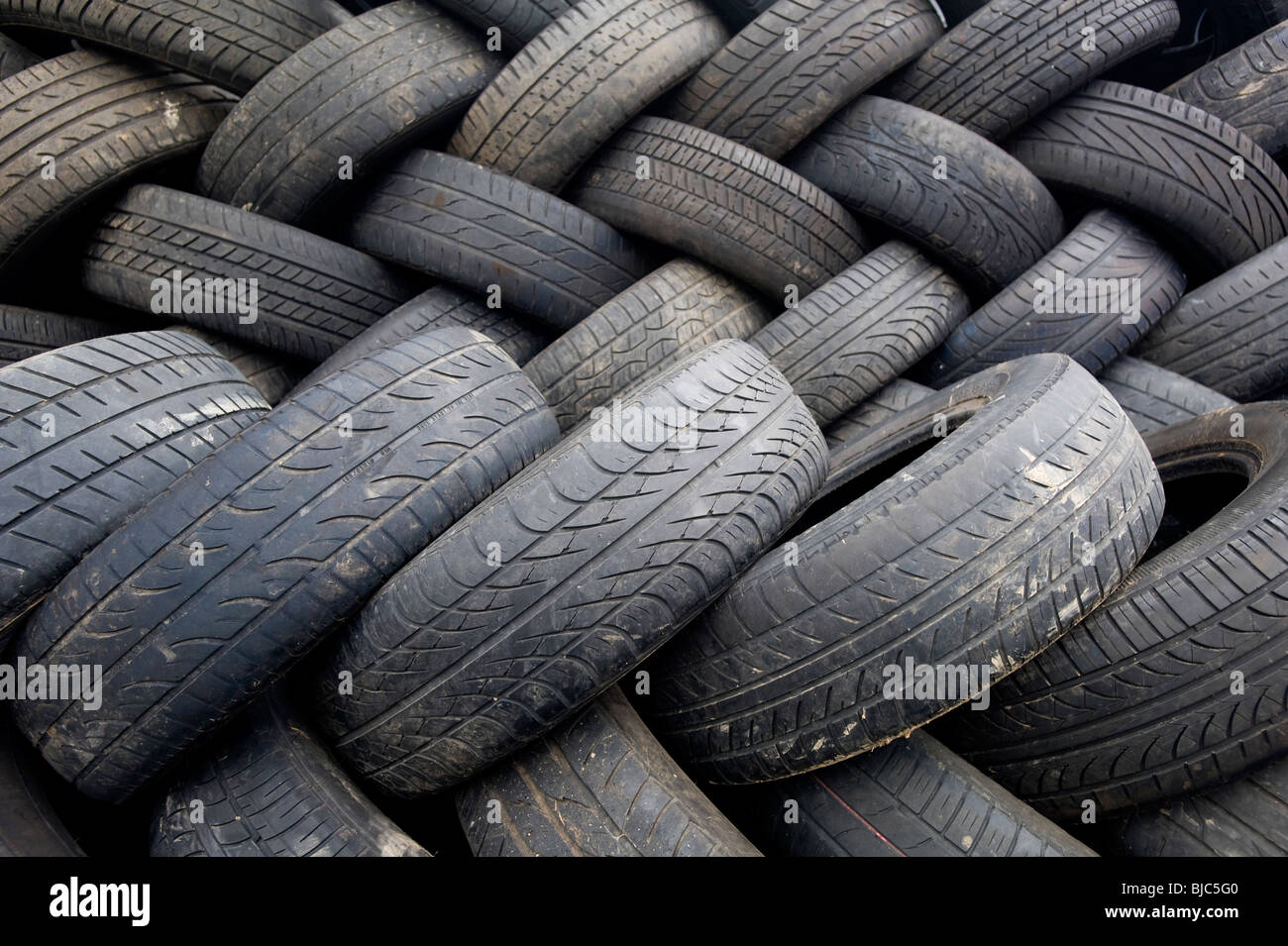 Waste car tyres stacked up in a pile waiting to be recycled Stock Photo ...