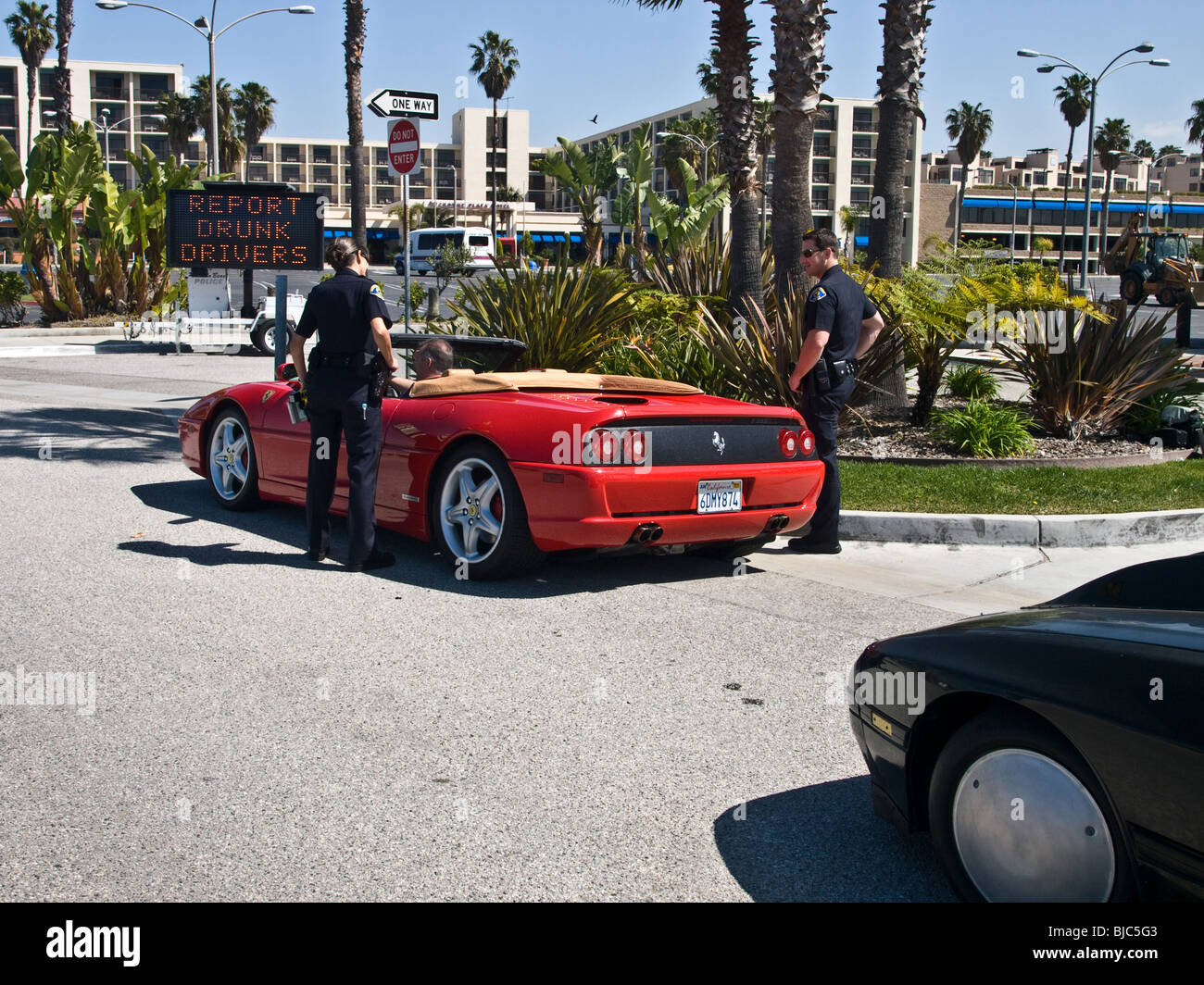 Male and female police officer question suspect Ferrari at DUI ...