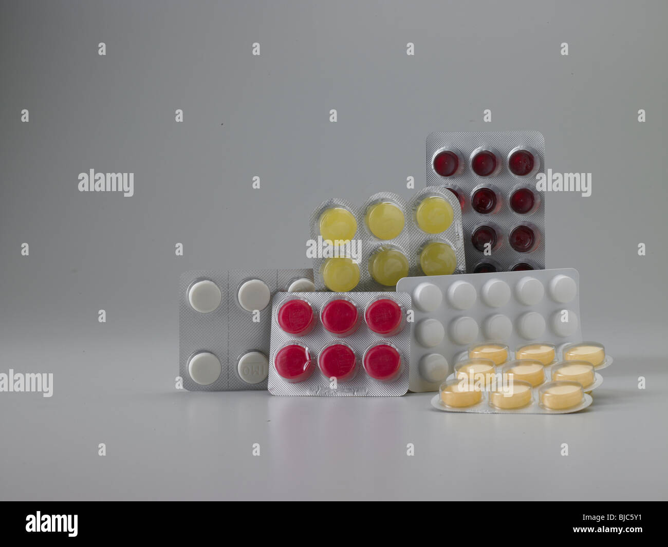 pharmaceutical tablets on grey background. Arranged in an upright ...